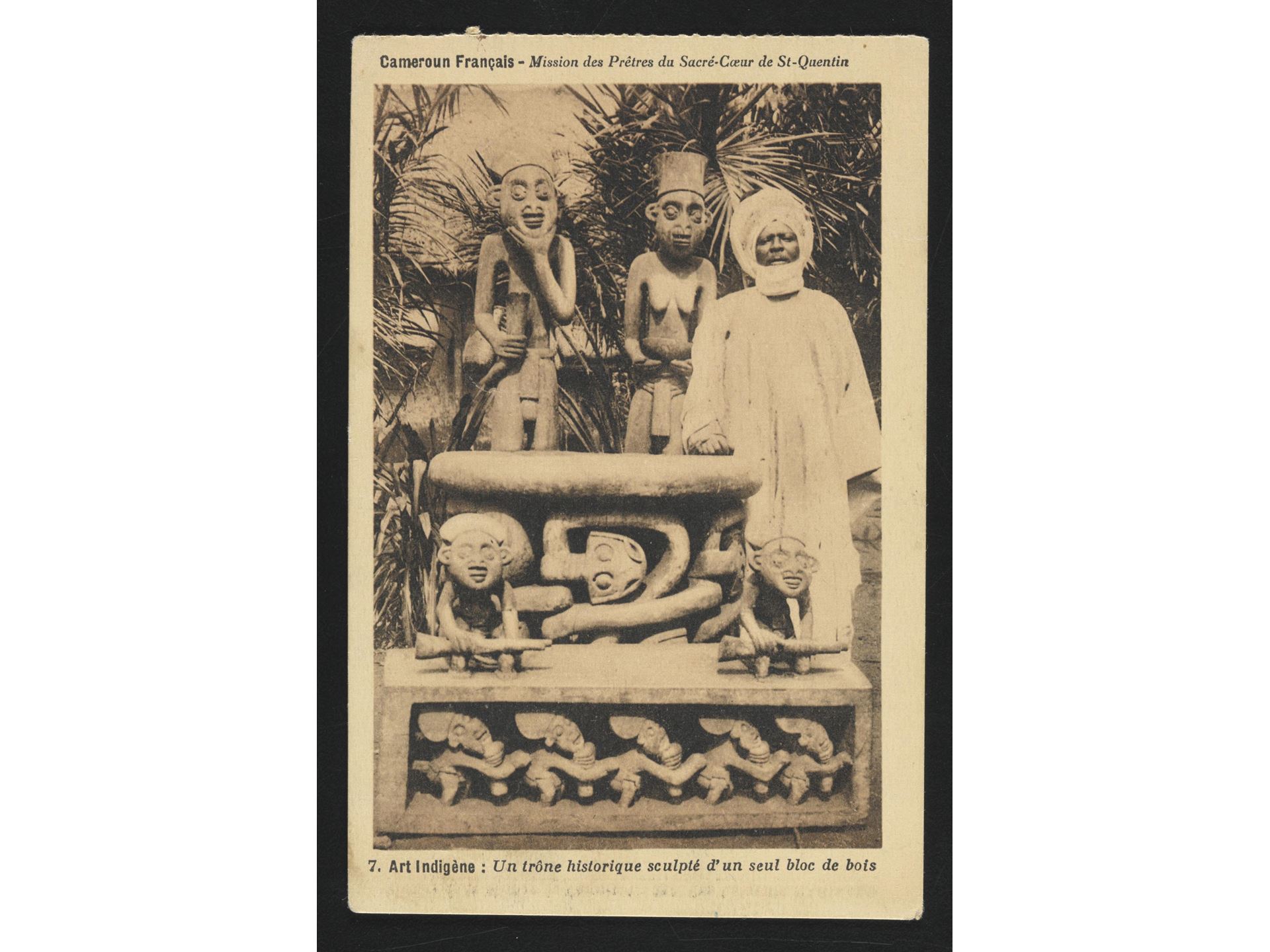 Sultan Ibrahim Njoya of Bamum standing beside his traditional throne